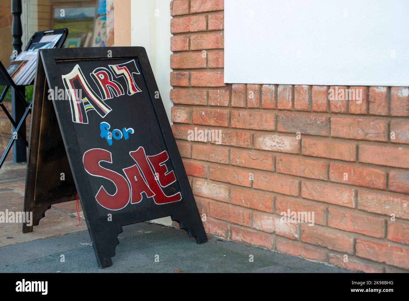 A rectangle shaped black painted wooden A framed sidewalk easel sign ...