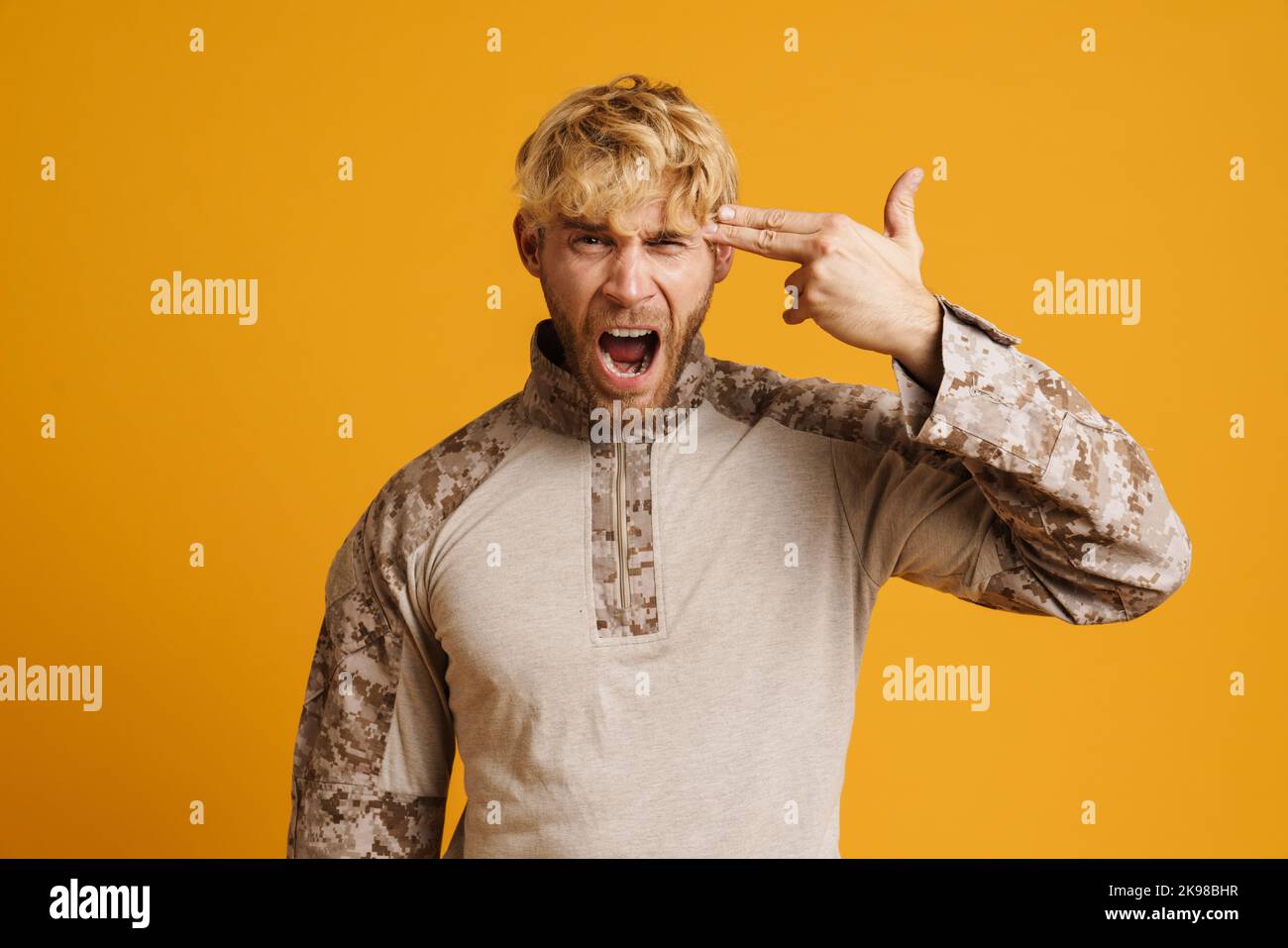 European military man wearing uniform making gun gesture and screaming ...