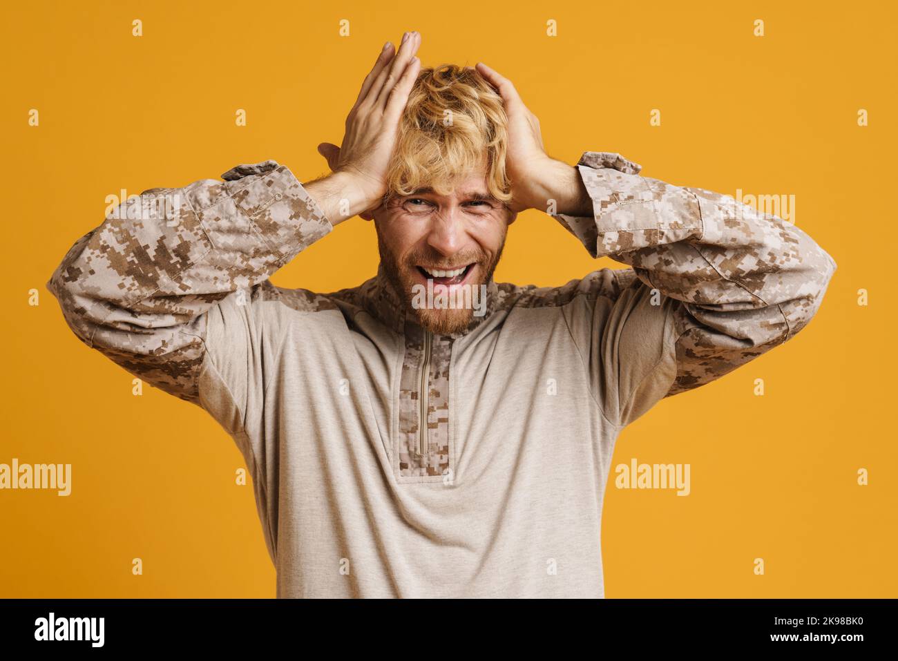 European military man with headache holding his head isolated over ...