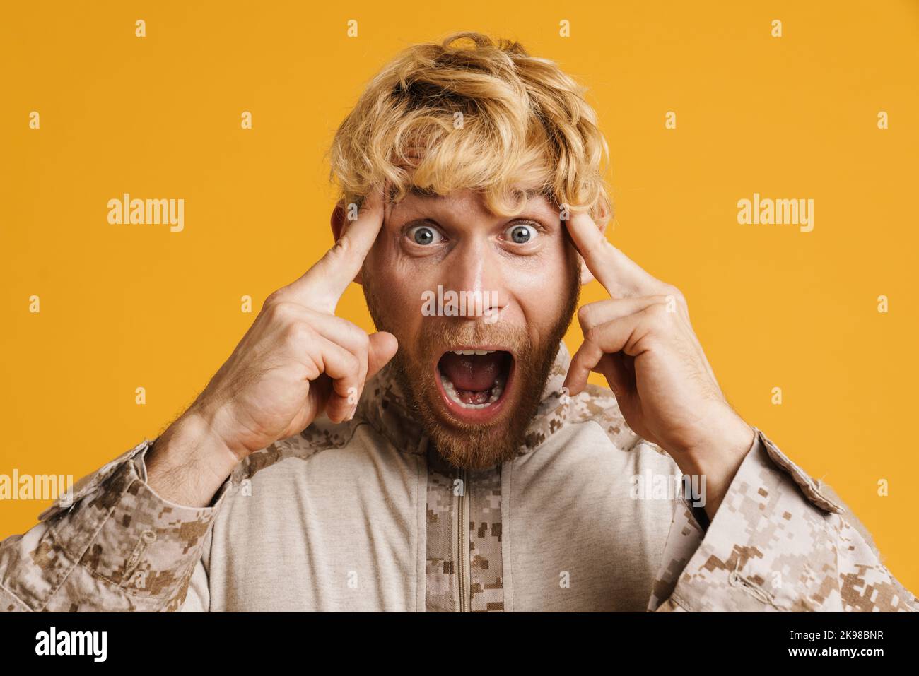 European military man with headache rubbing his temples isolated over ...
