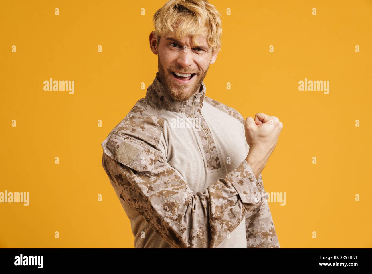 European military man wearing uniform showing his bicep at camera ...