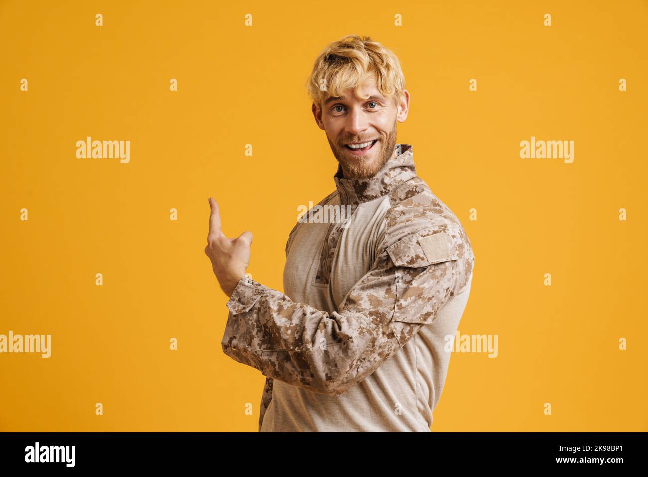 European military man wearing uniform smiling and pointing finger ...