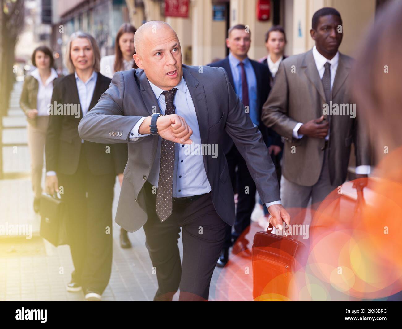 Stressed businessman checking time and running Stock Photo - Alamy