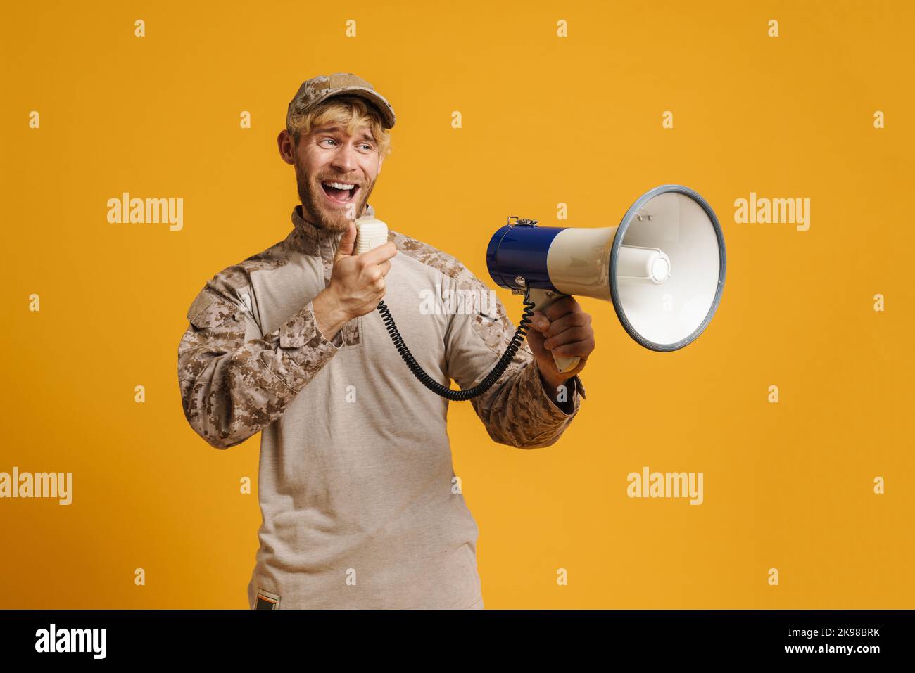 European military man wearing uniform shouting in megaphone isolated ...