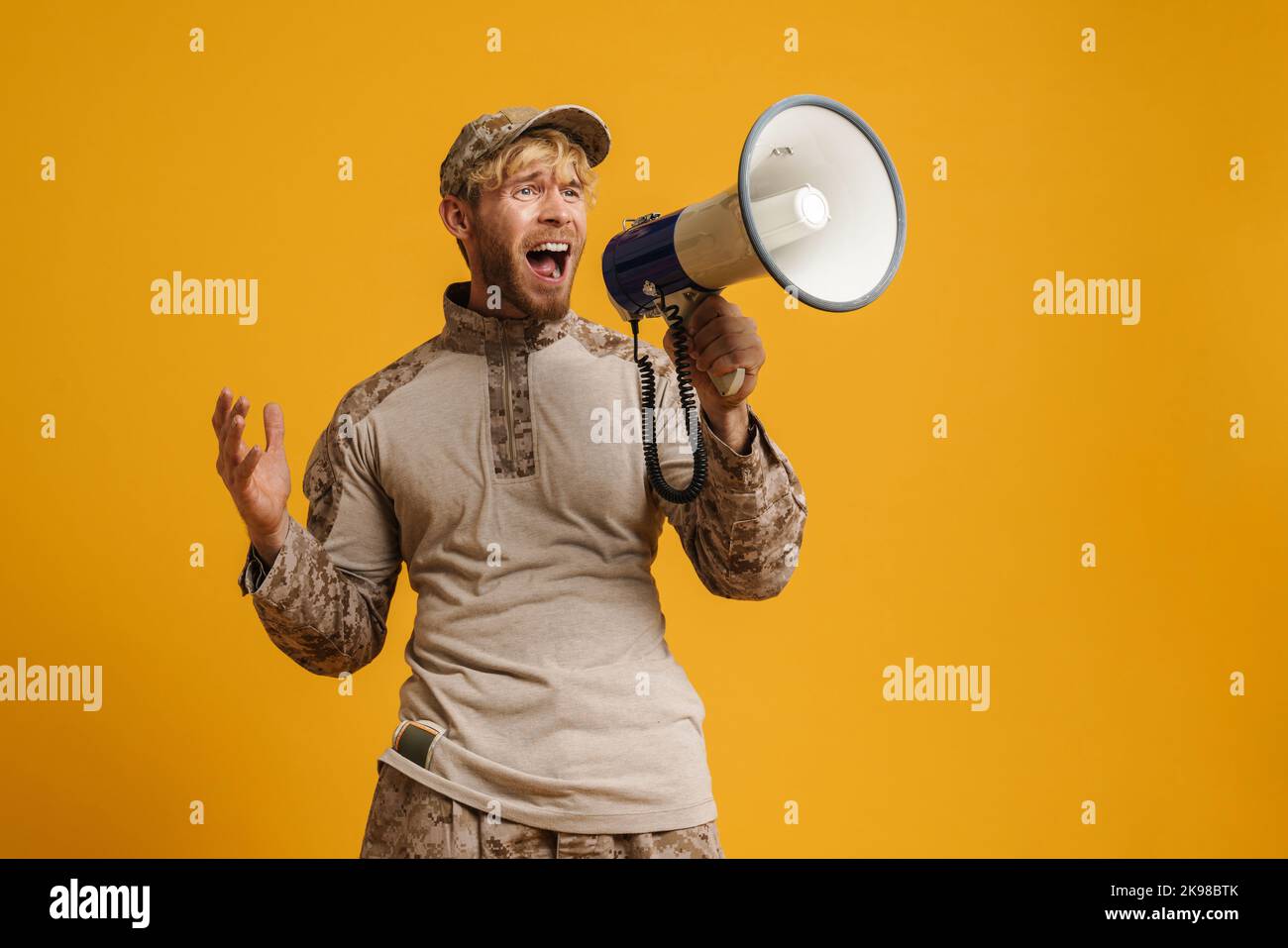 European military man wearing uniform shouting in megaphone isolated ...