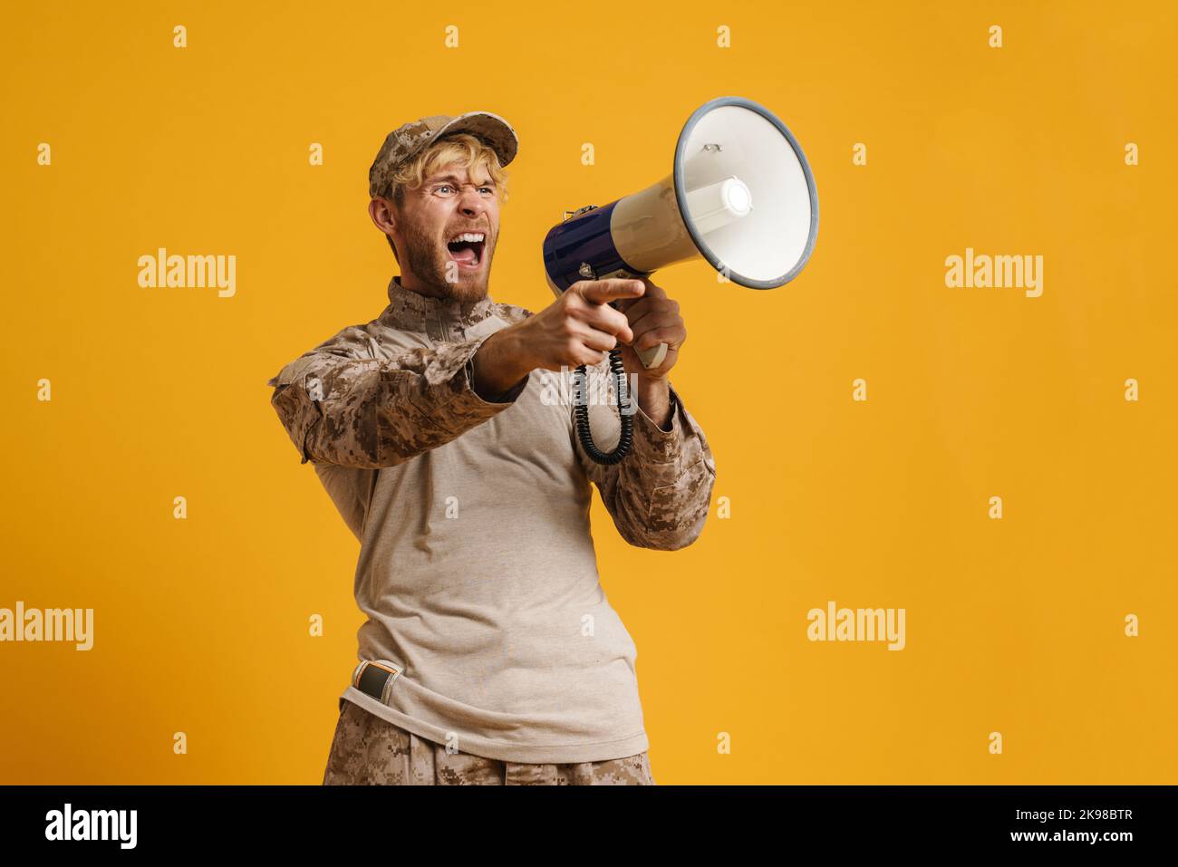 European military man wearing uniform shouting in megaphone isolated ...