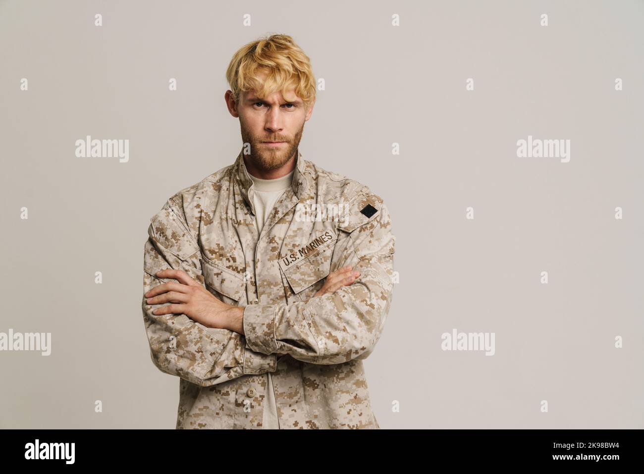 European military man wearing uniform posing with arms crossed isolated ...