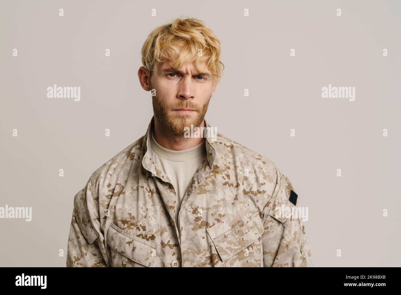 White military man wearing uniform frowning and looking at camera ...