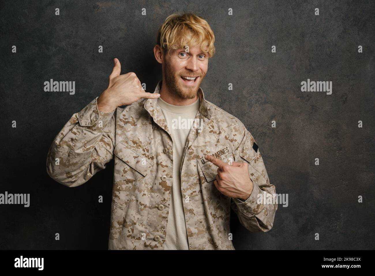 White military man wearing uniform gesturing and pointing finger away ...