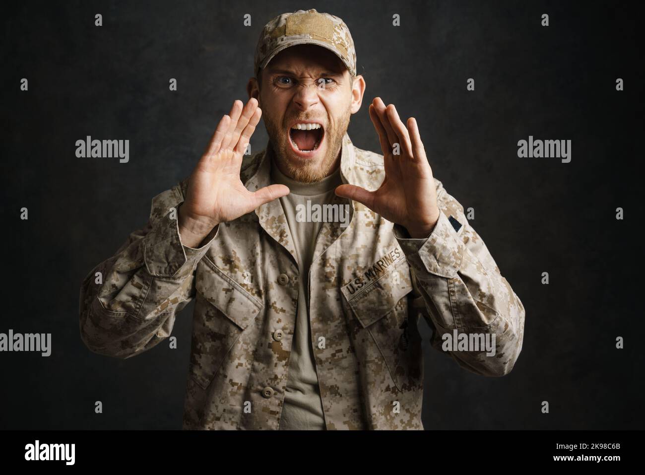 White military man wearing uniform gesturing and screaming at camera ...