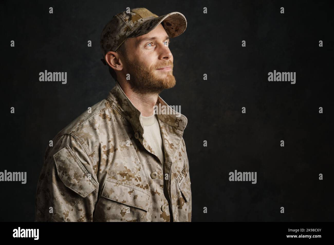 White military man wearing uniform smiling and looking aside isolated ...