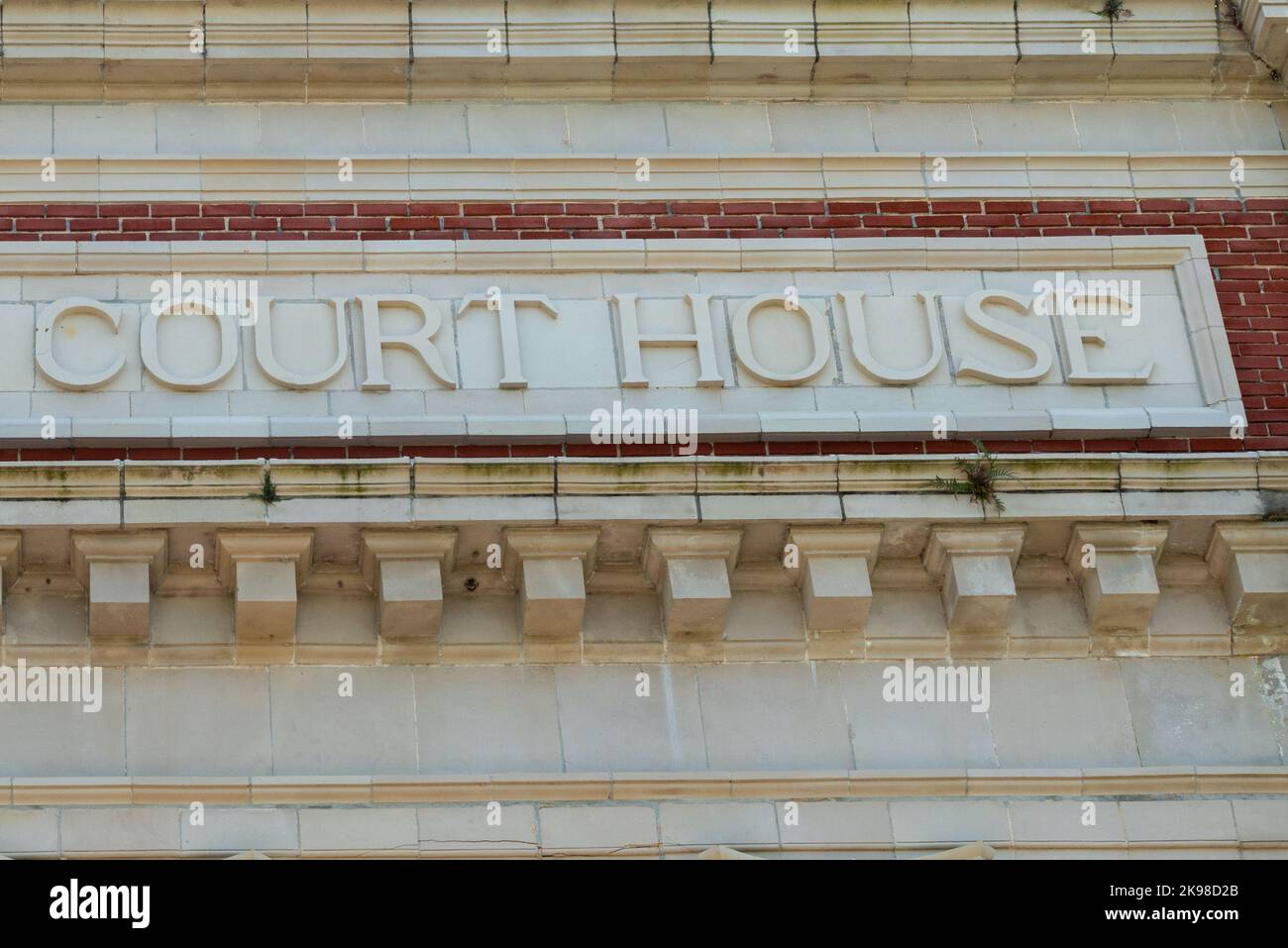 The exterior of a historical red brick judicial building with a ...