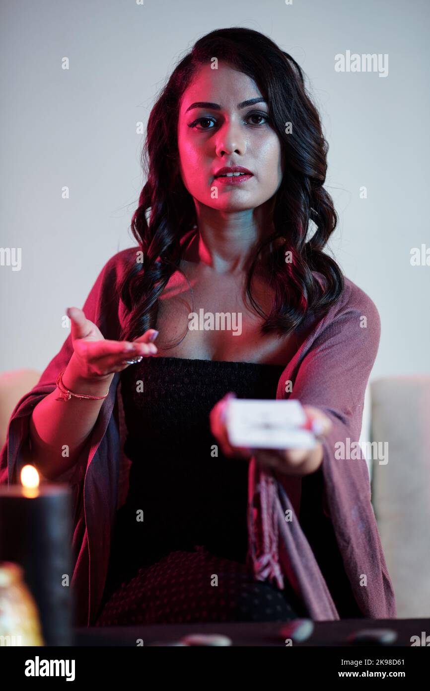 Young woman asking to remove upper tarot cards from deck Stock Photo ...