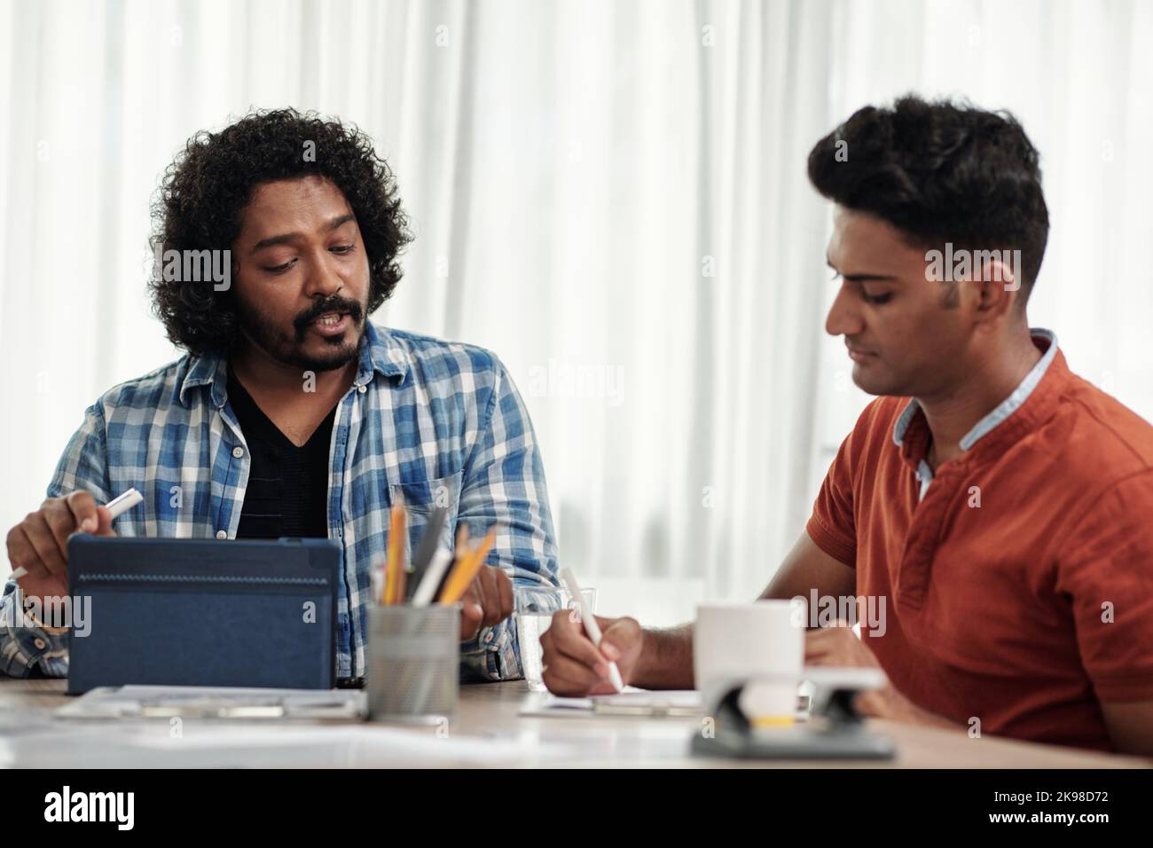 Product manager and software developer discussing project of new ...