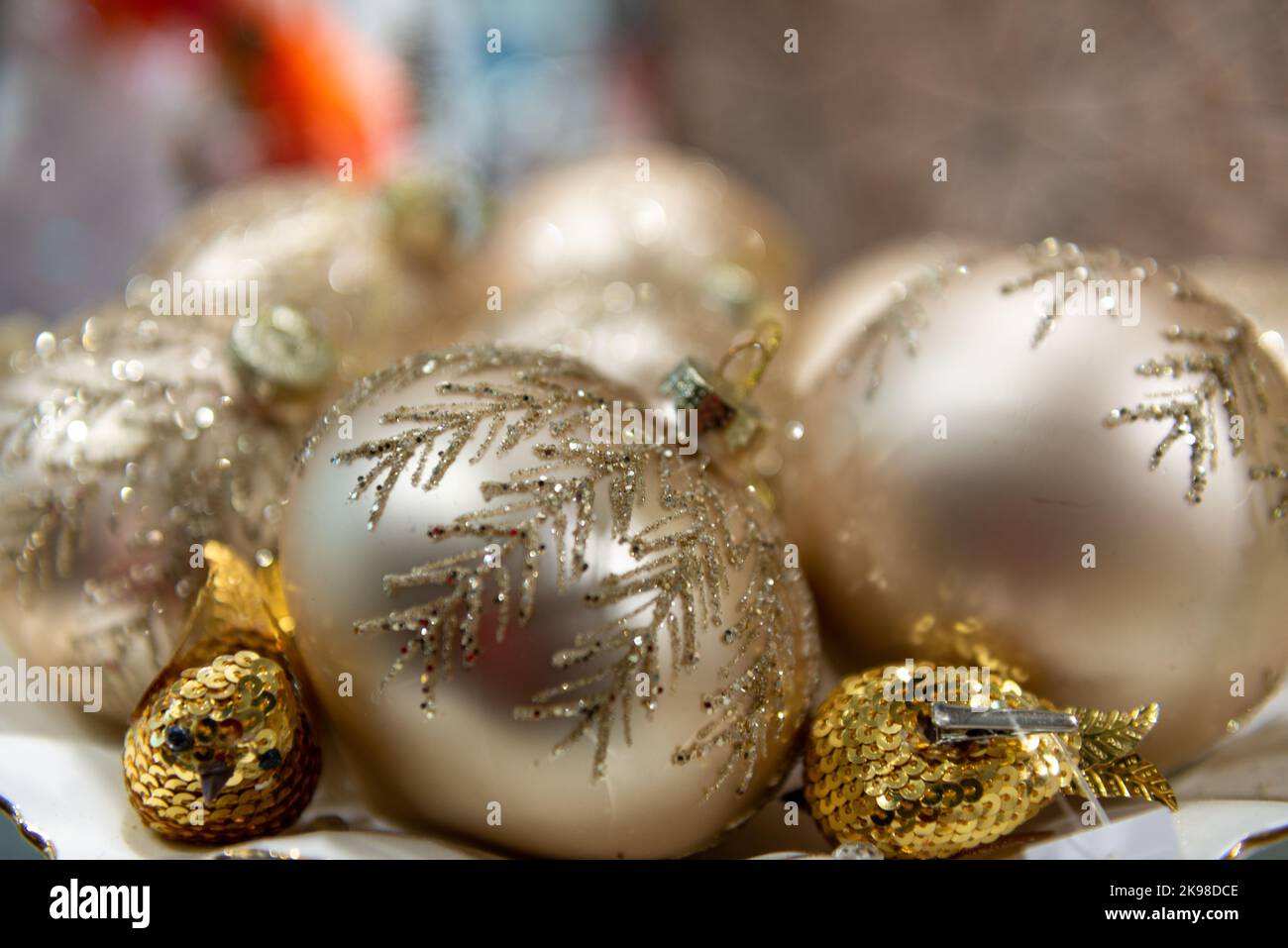 A group of gold colored round Christmas tree glass bulbs with glitter ...