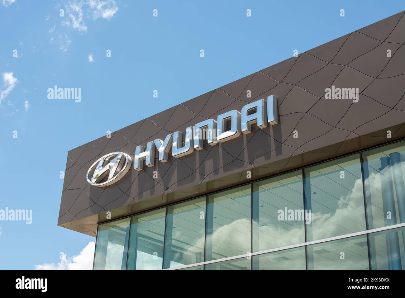 The corner of a building with a Hyundai sign and logo. The silver text ...
