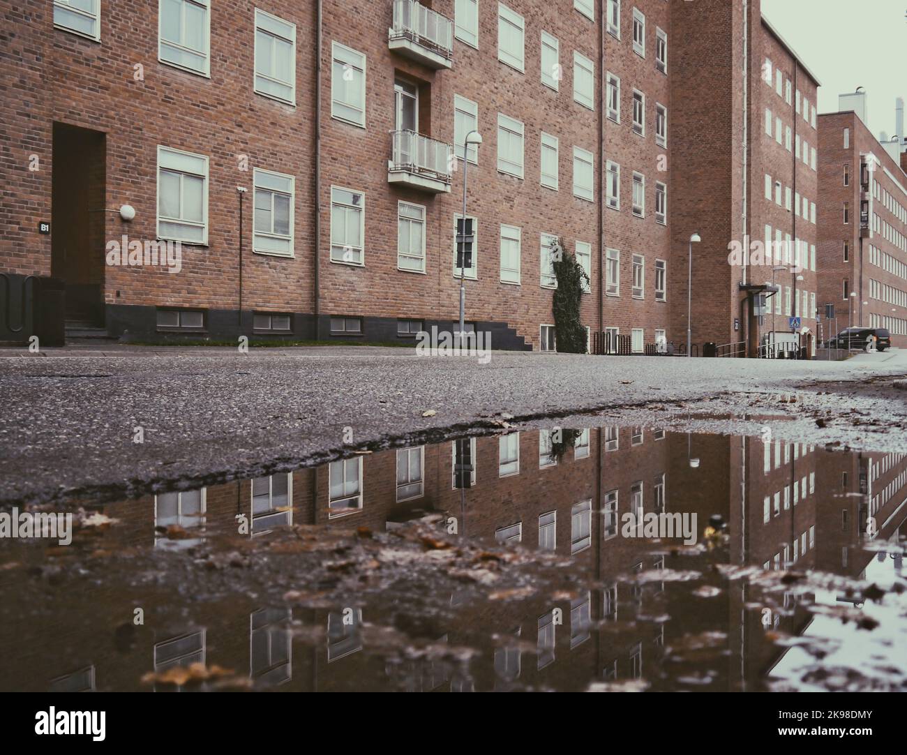 Big puddle on a street next to buildings Stock Photo - Alamy