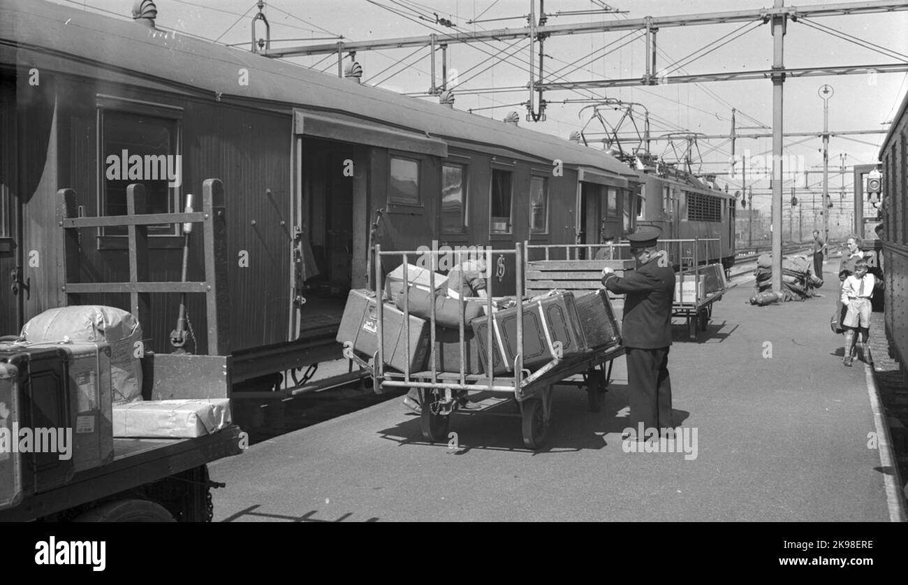 State Railways, SJ Landstand. SJ Security Service. Station man loads ...