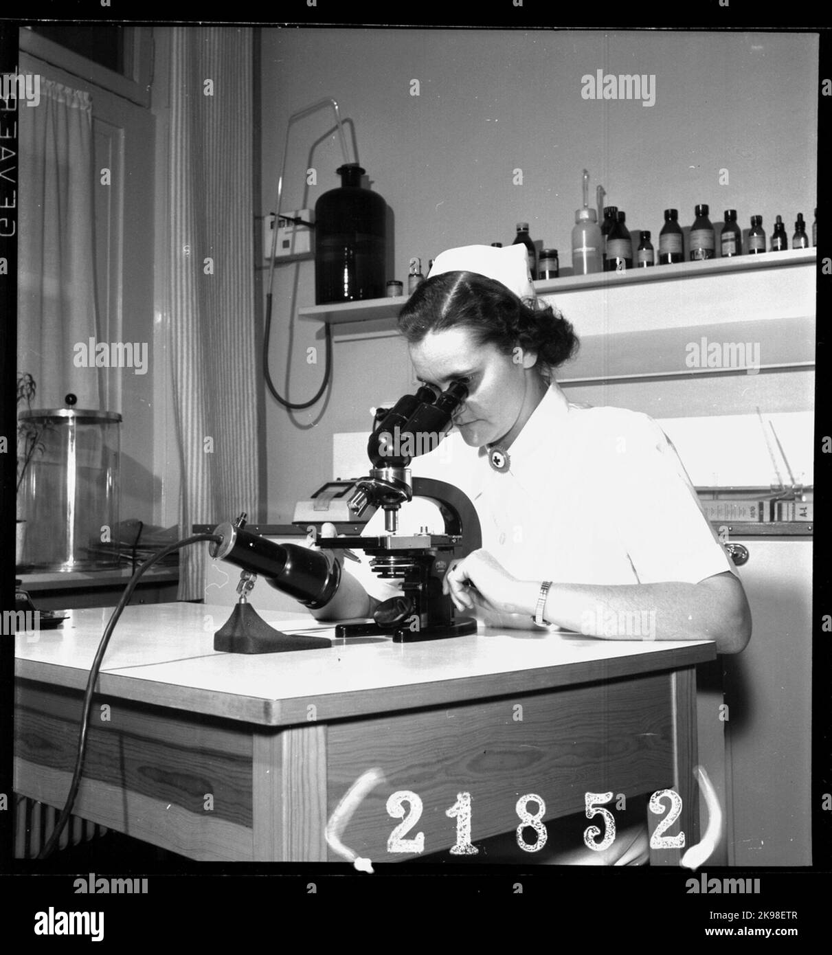 Medical clinic. Sister Birgit at a microscope Stock Photo - Alamy