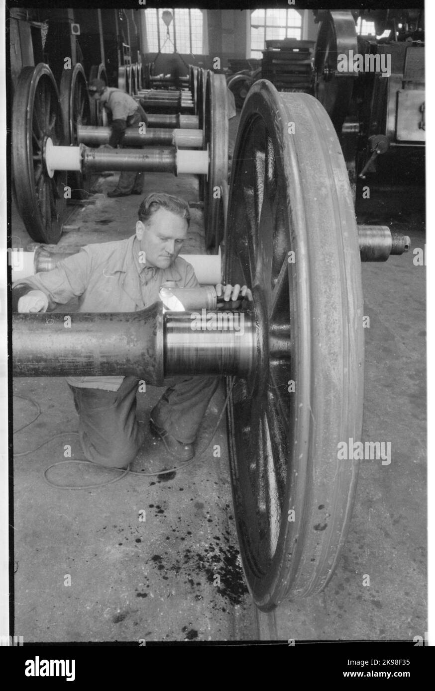 Workshop workers control the wheel axle on the wheel pair Stock Photo ...