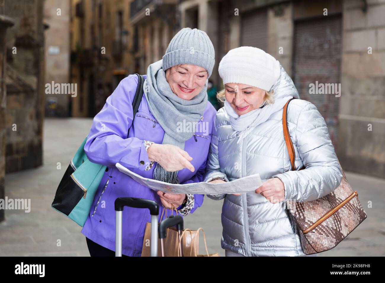 Elderly women tourists with city guide Stock Photo - Alamy