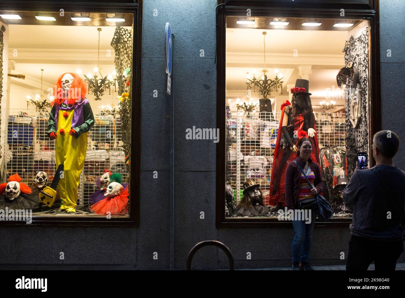A woman is photographed by her partner in the window with one of the ...