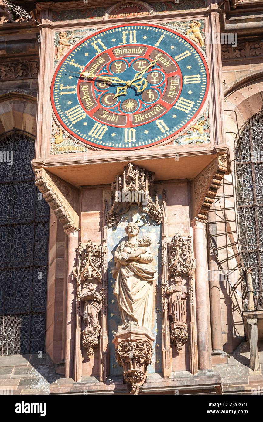 The statue of Mary and a clock on the Gothic facade of the Strasbourg ...