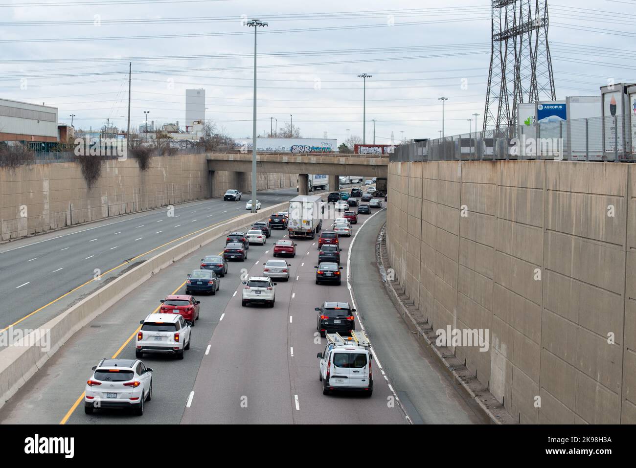 rush hour traffic of cars and trucks on a city divided roads ...