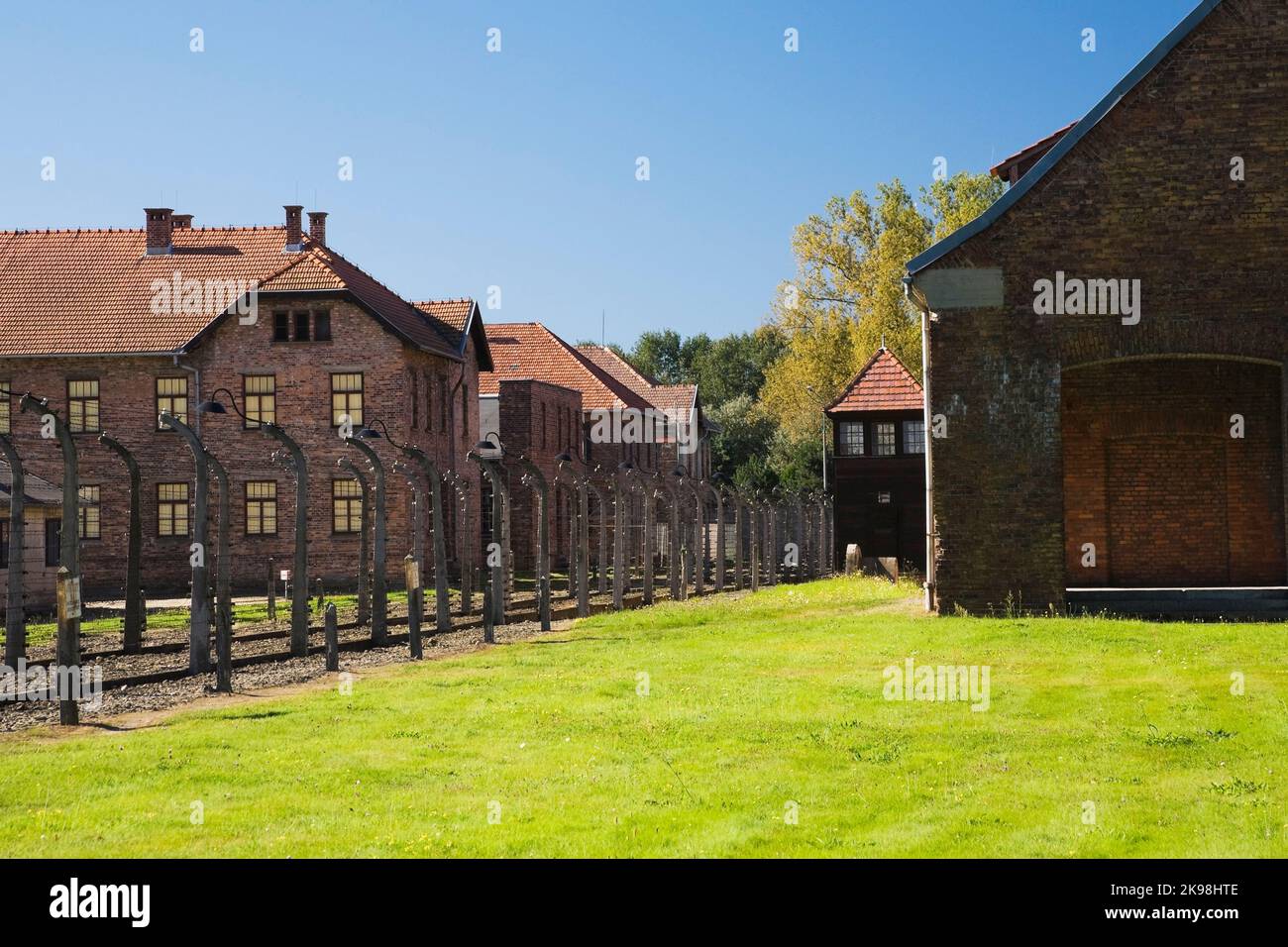 Electrified barbwire fences and buildings in the Auschwitz I former ...
