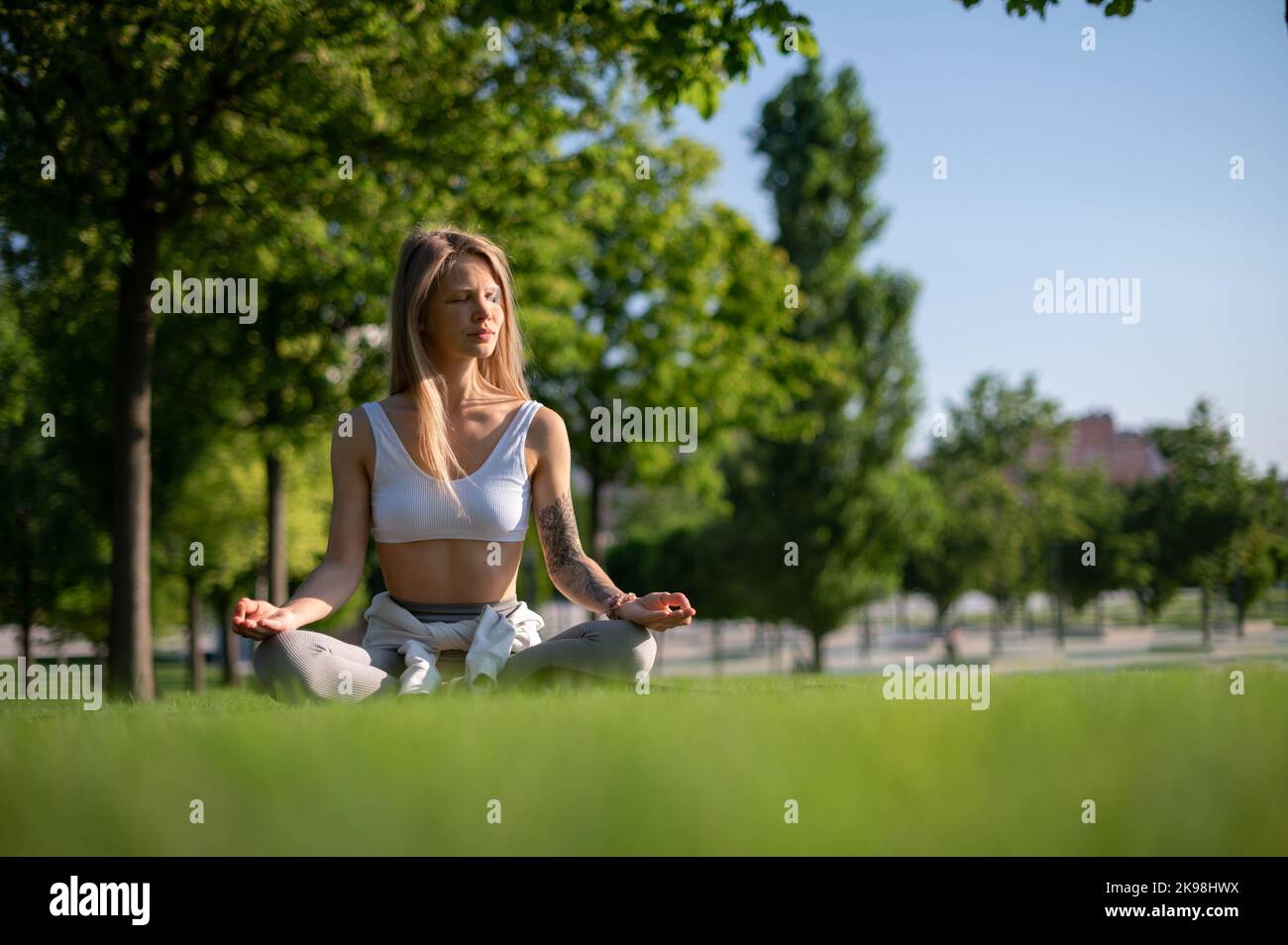 Girl practice yoga meditation outdoor in park Stock Photo - Alamy