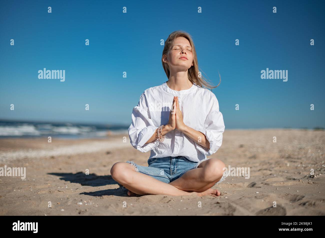 Girl practice meditation on the beach. With space for text or design ...