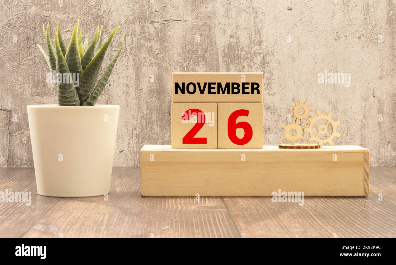 Wood calendar with date and old clock. Tuesday 26 November Stock Photo ...