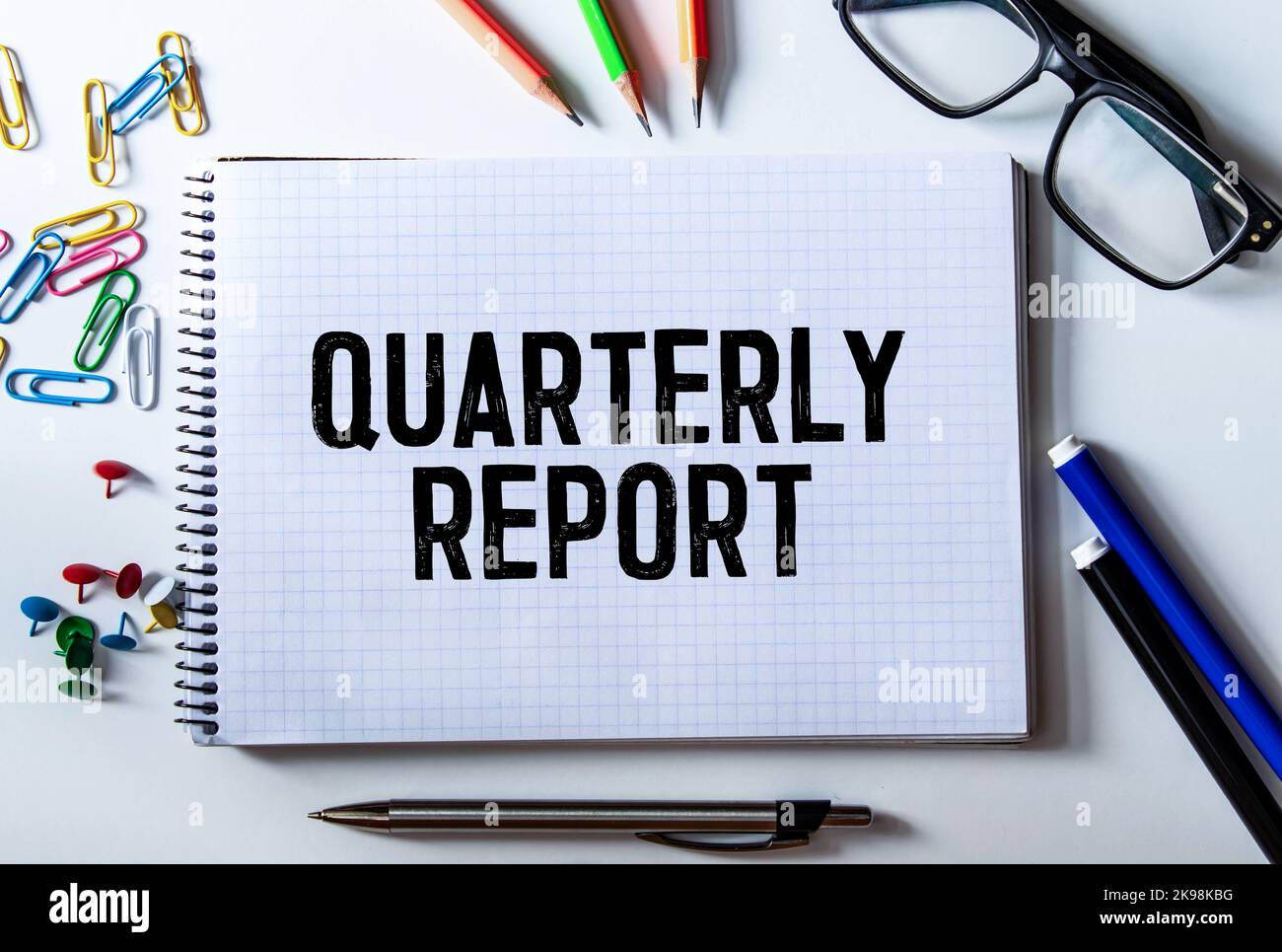 Paper with text QUARTERLY REPORT on the table on chart Stock Photo - Alamy