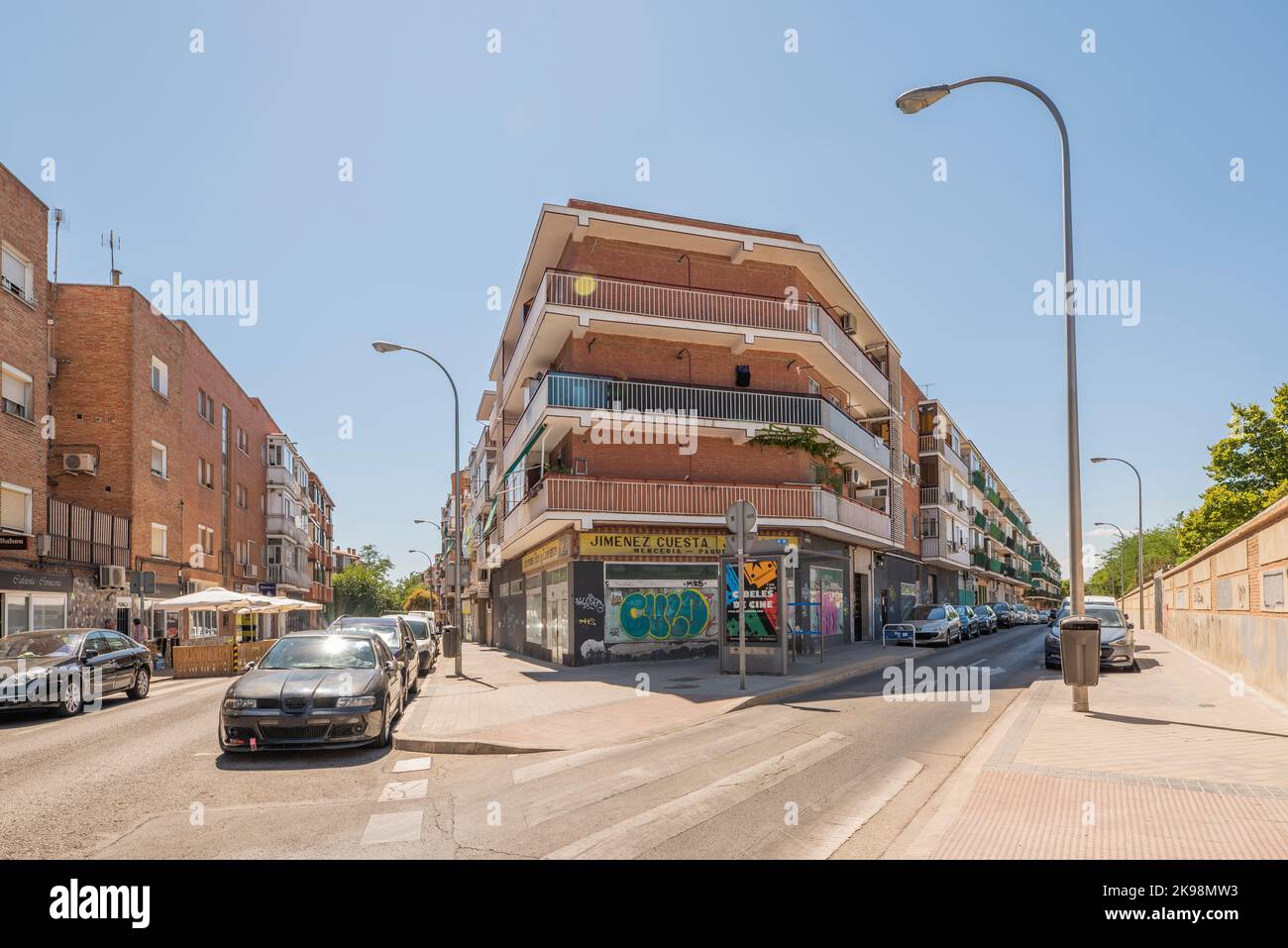 Facades of modest brick urban residential buildings with balconies ...