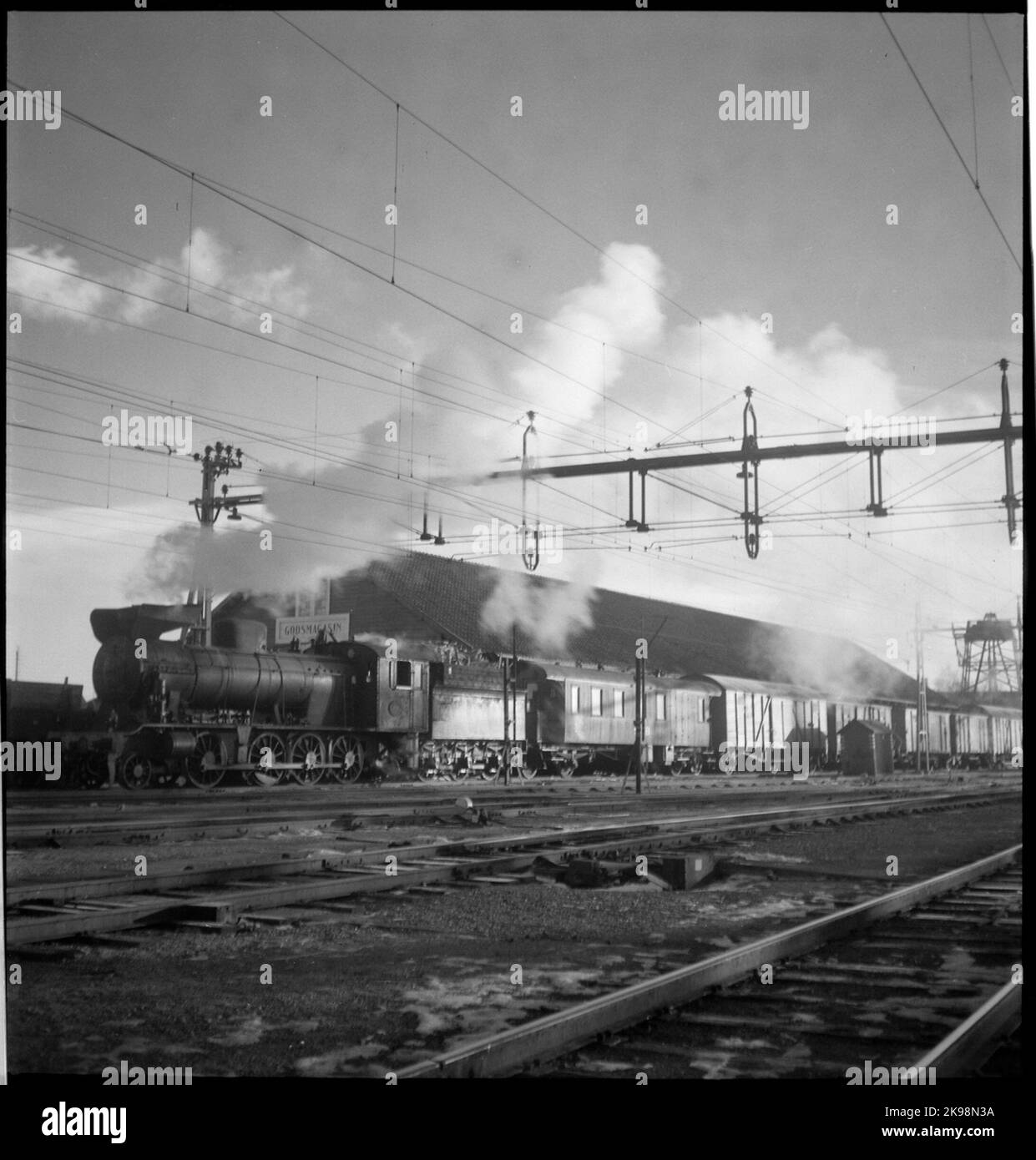 Freight train at freight warehouse Stock Photo - Alamy