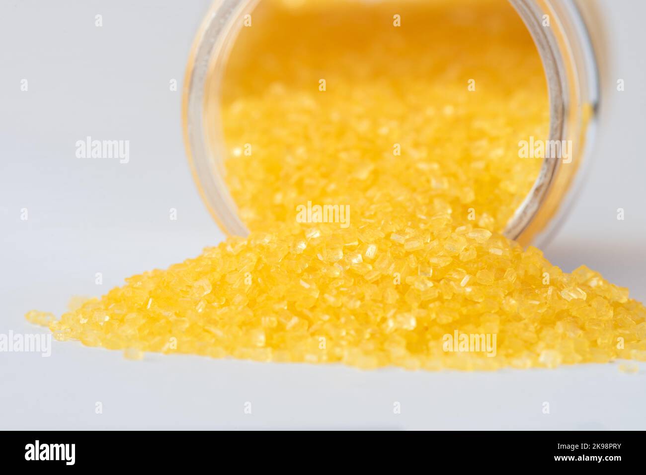 Yellow Sugar Crystals Spilled from a Jar Stock Photo - Alamy