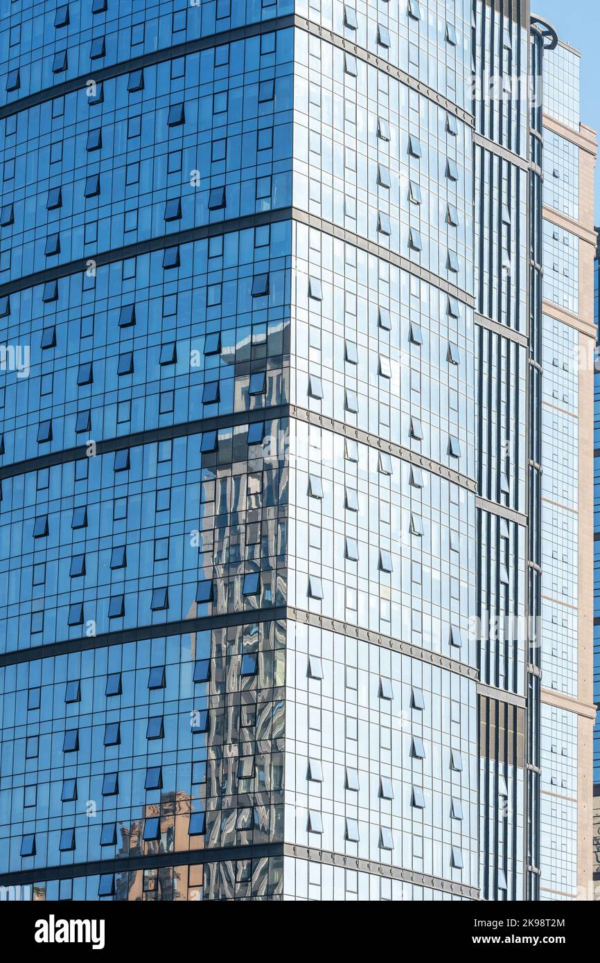 A beautiful background of an glass office building, reflecting clouds ...