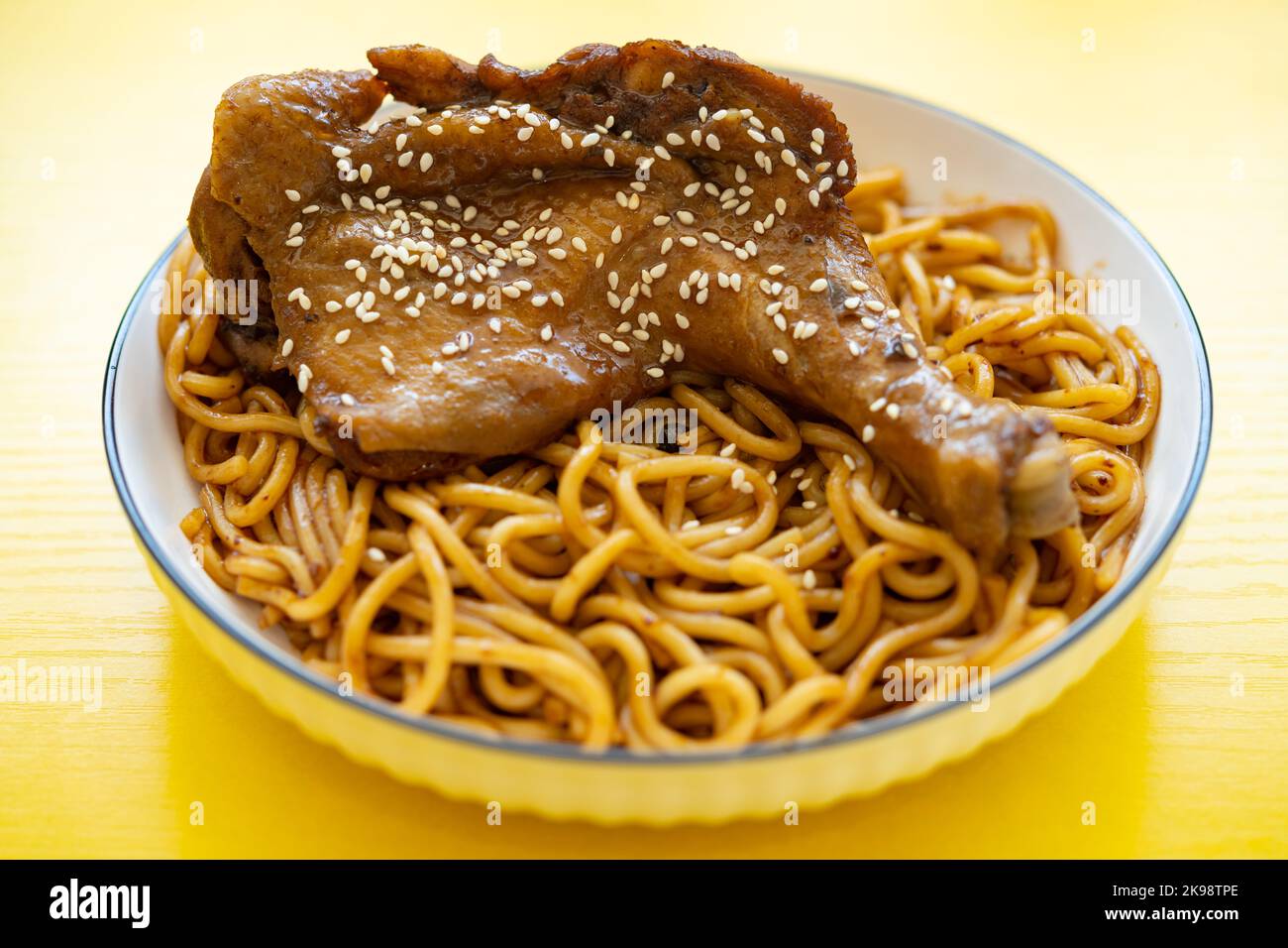 angle view dish of cart noodles with braised chicken leg at horizontal ...