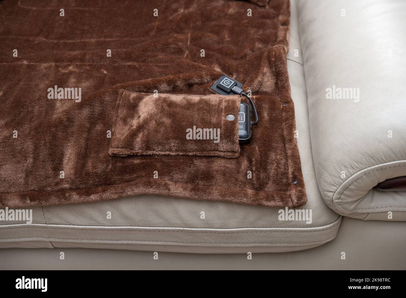 lectric blanket with portable charger as a power supply on a sofa Stock ...