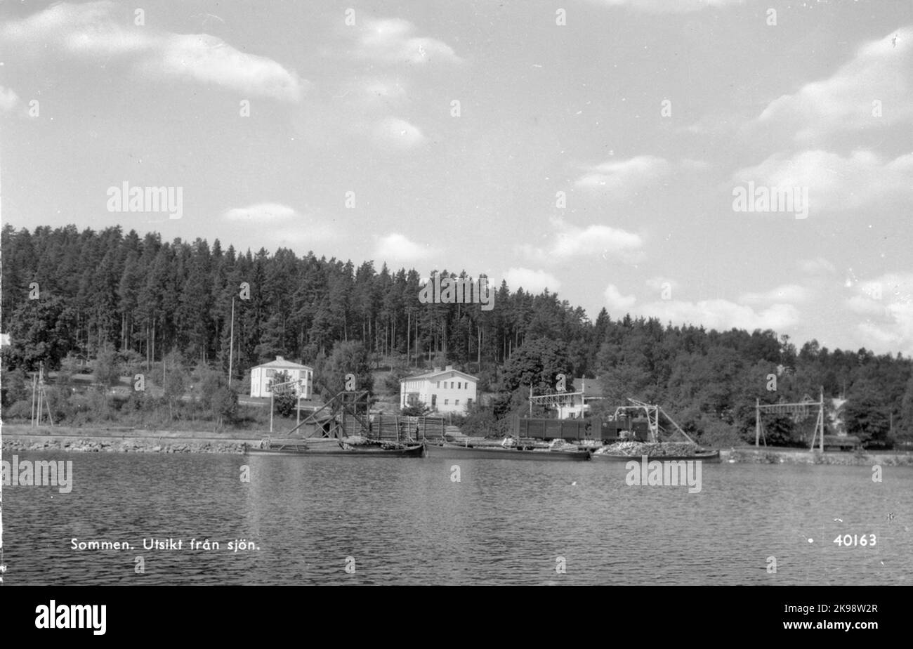 Loading of timber between barges and freight wagons at Sommen Stock ...
