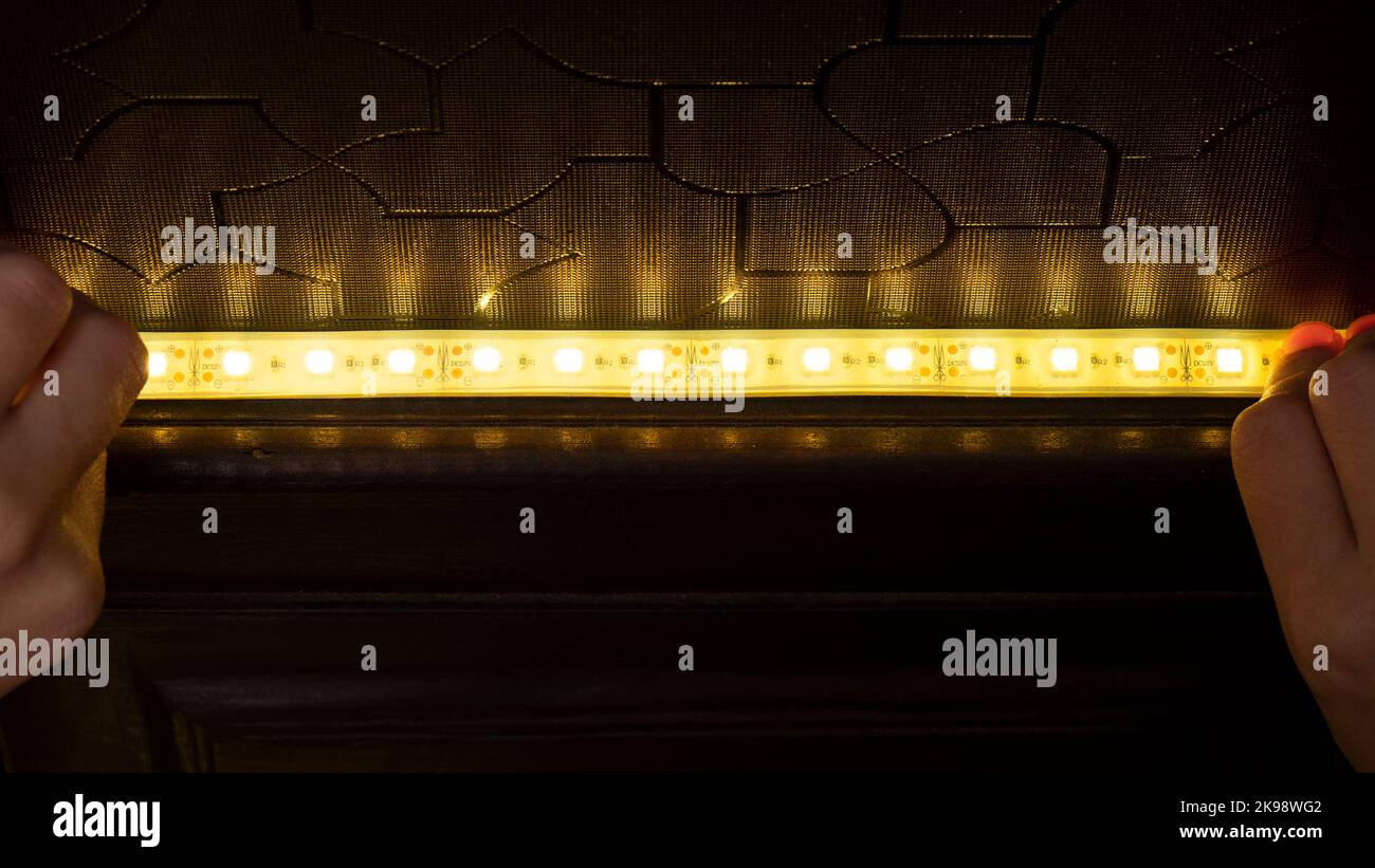 gluing instal decorative LED strip light Stock Photo - Alamy