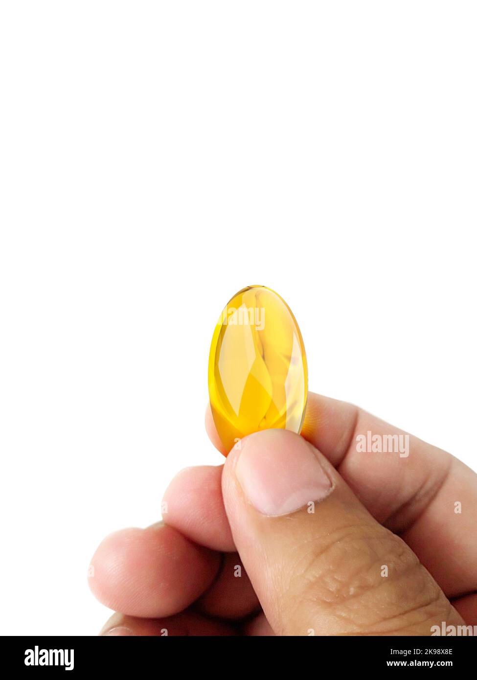 Hand holding omega 3 capsules on white background close up high ...