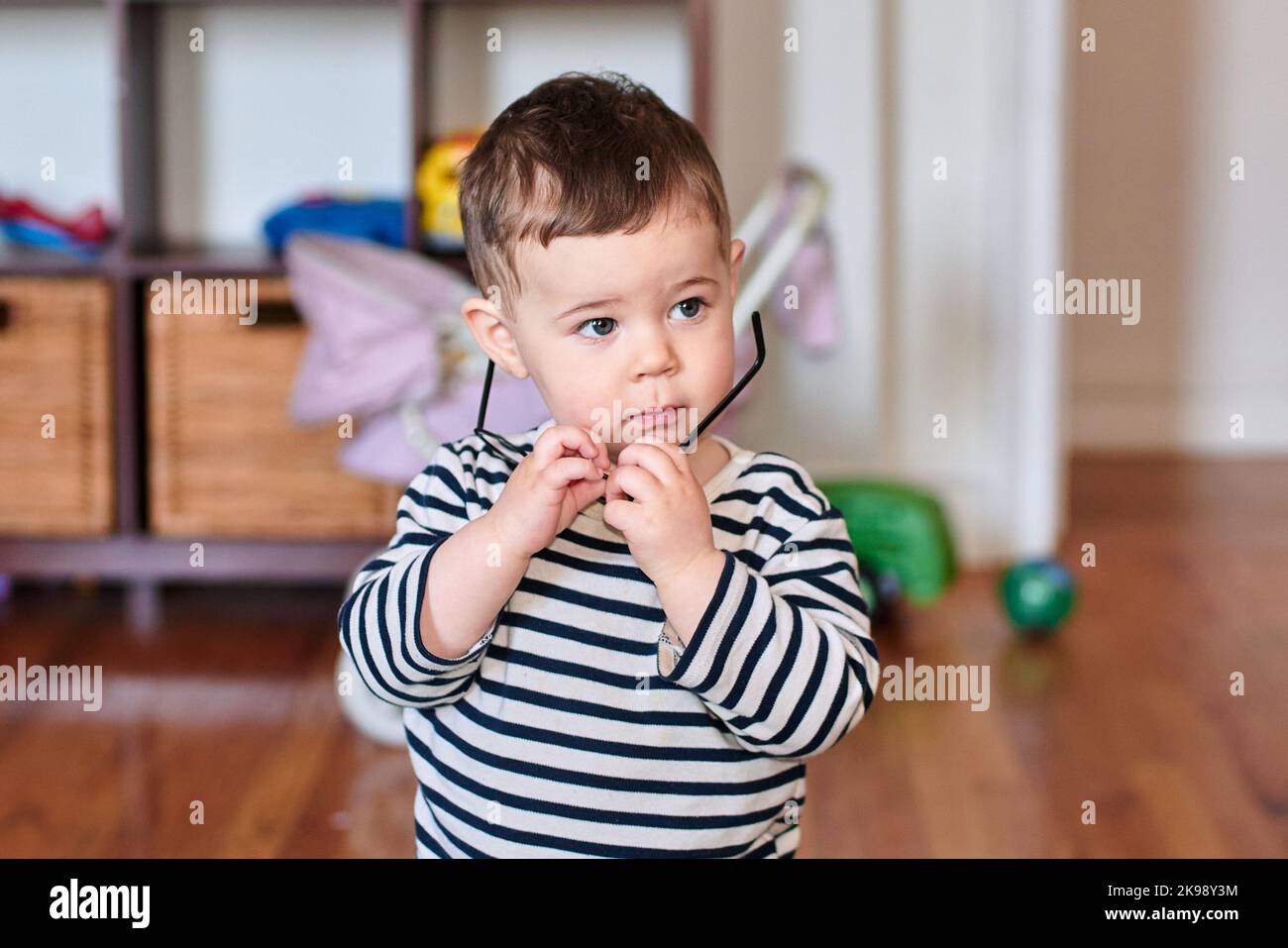 cute baby boy is playing with toy glasses Stock Photo - Alamy