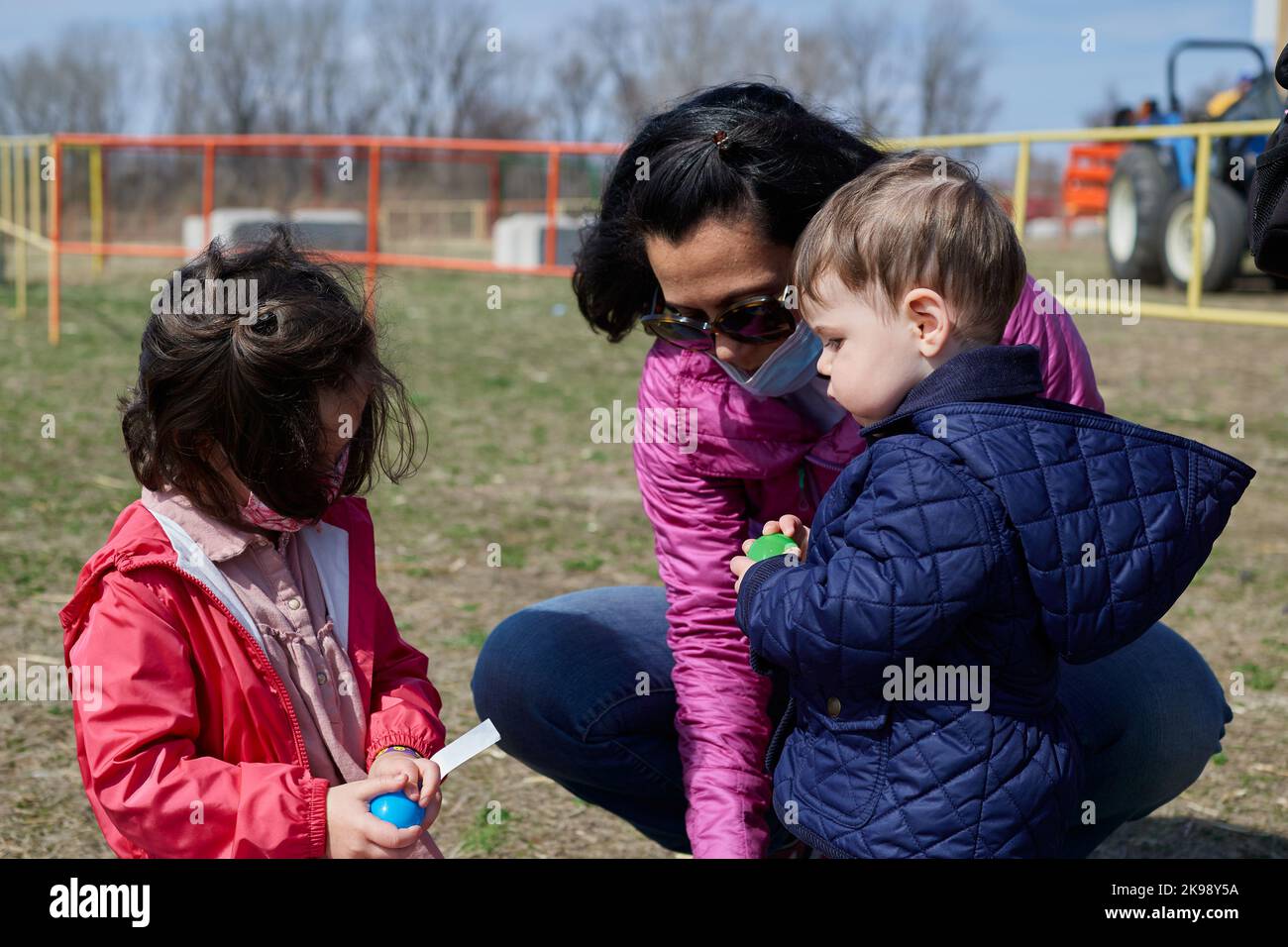 Masked mom with kids at the county fair Stock Photo - Alamy