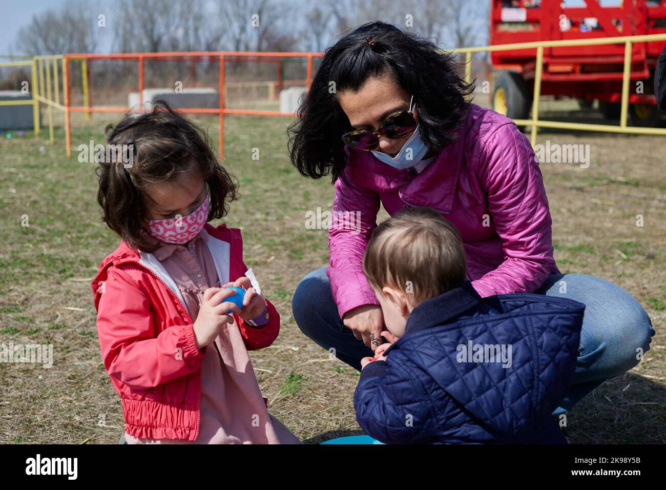 Masked mom with kids at the county fair Stock Photo - Alamy