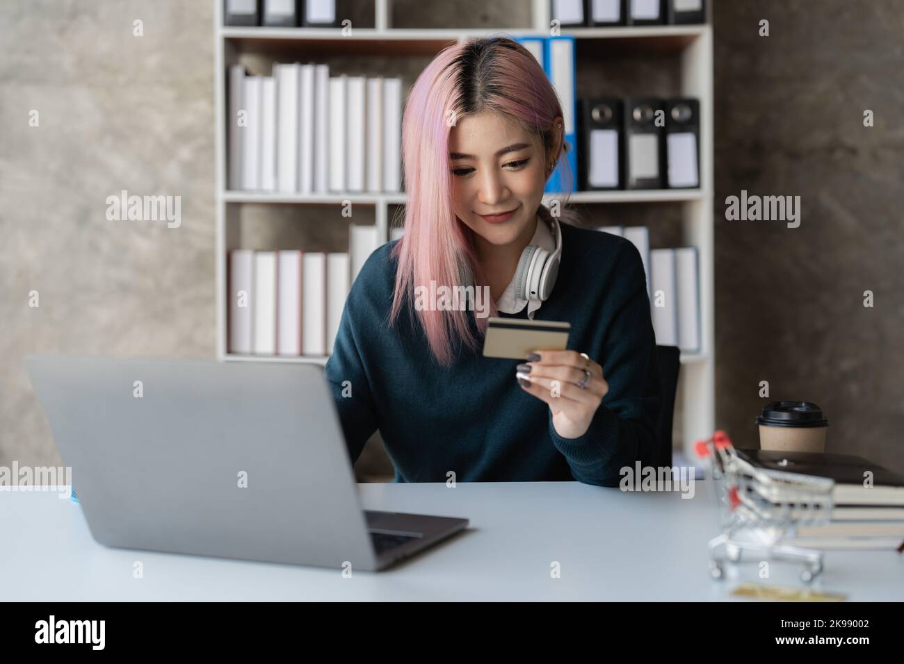 Young person using credit card and laptop computer. Online shopping, e ...