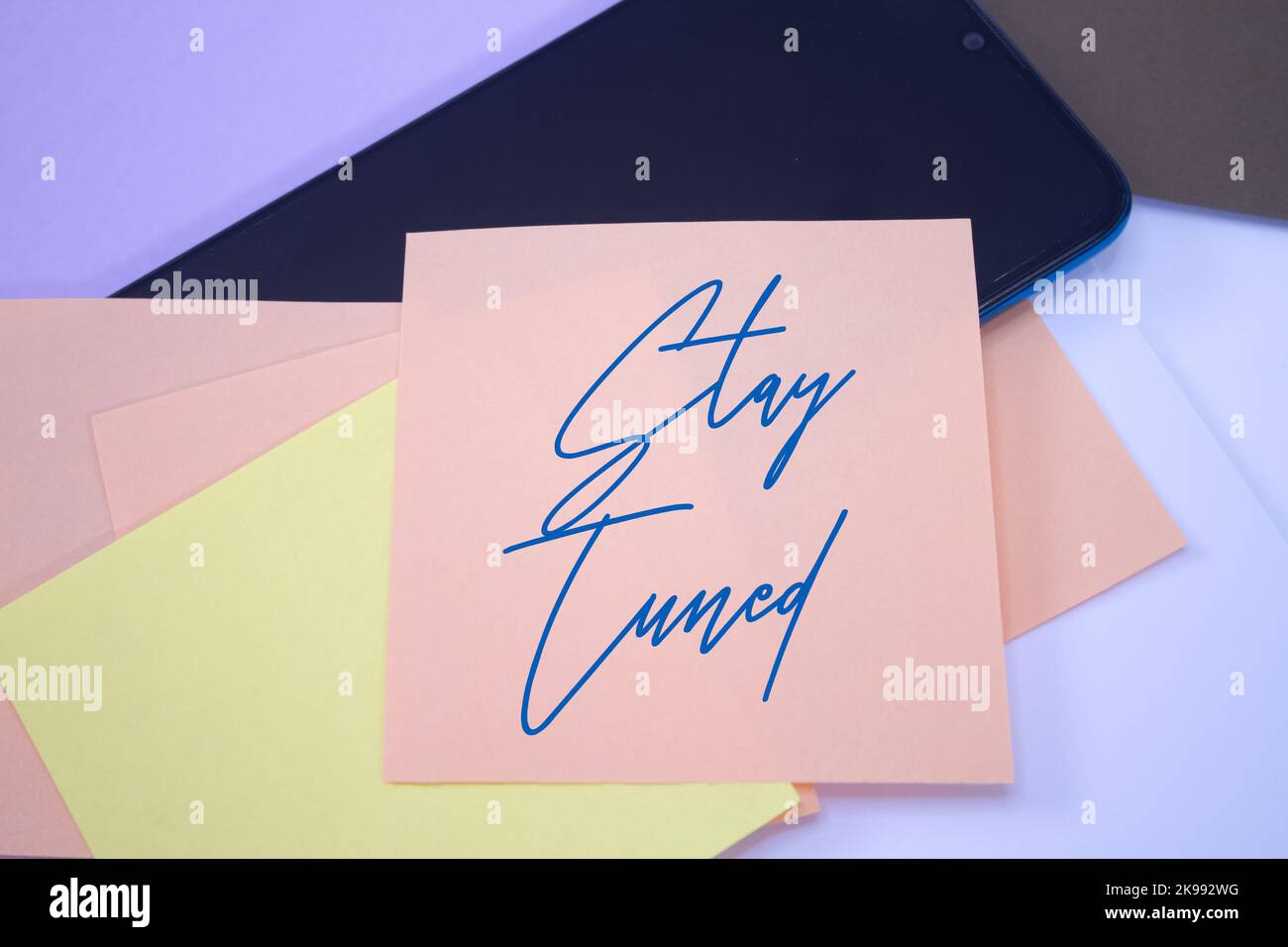 Stay Tuned. Text on adhesive note paper. Event, celebration reminder ...