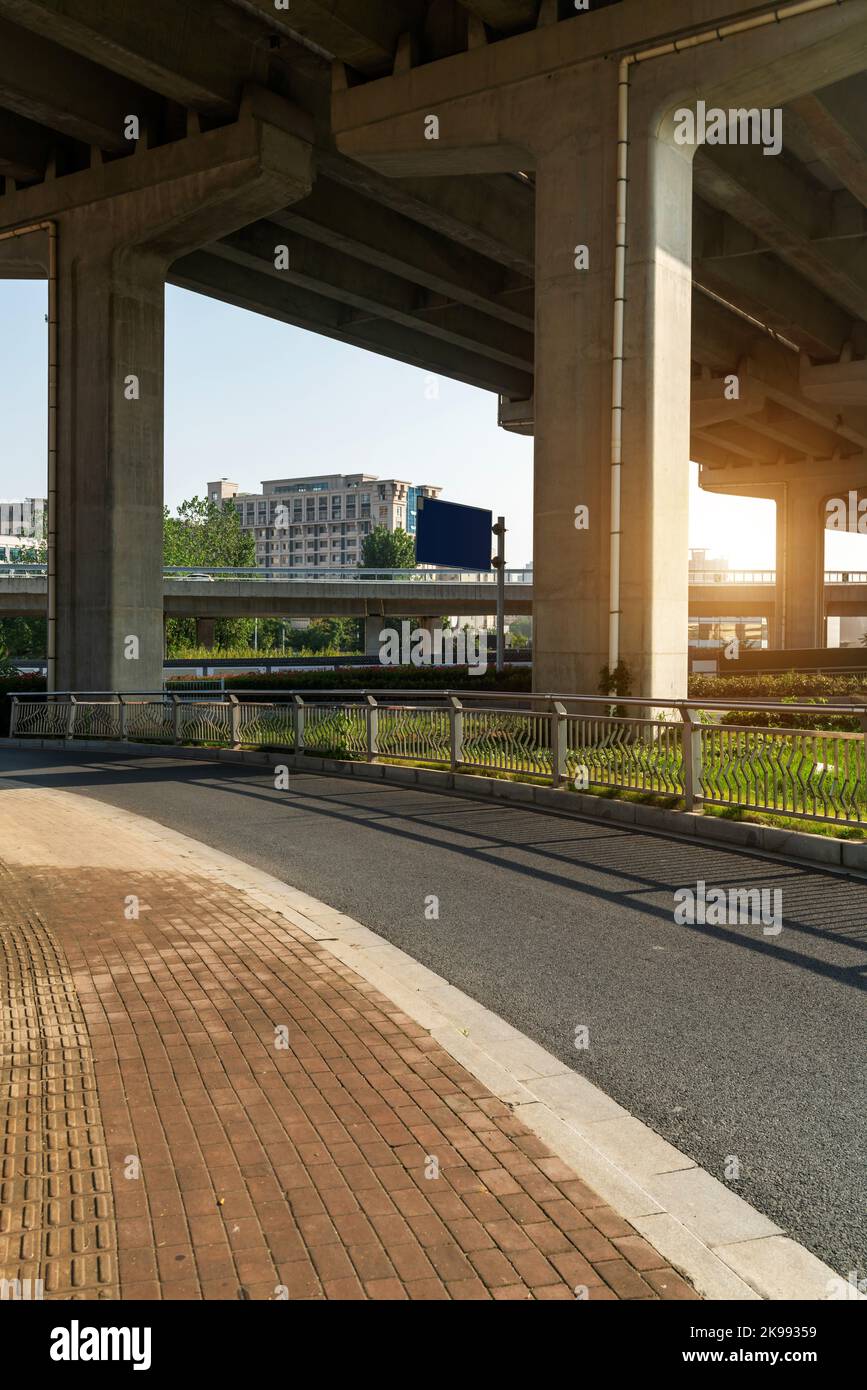 Concrete structure and asphalt road space under the overpass in the ...