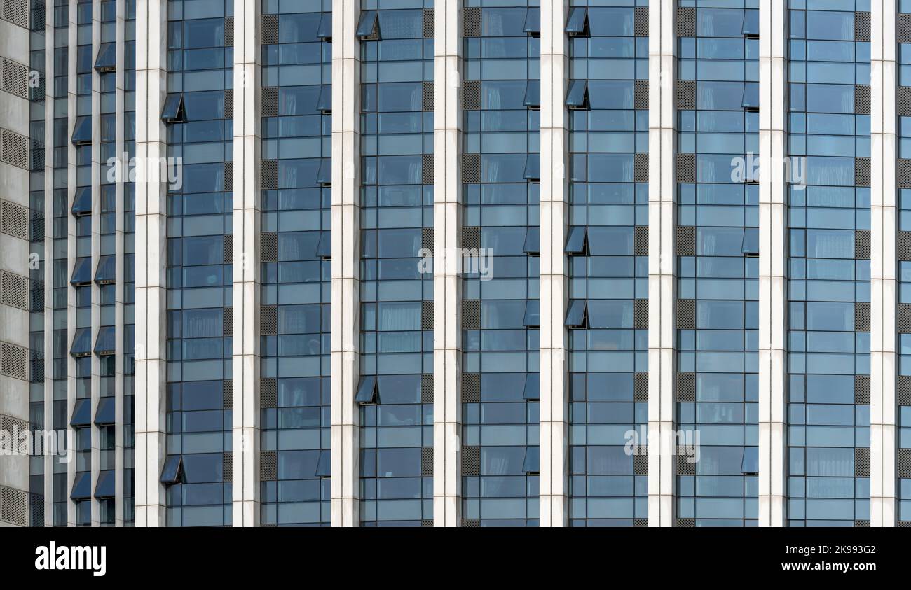 A beautiful background of an glass office building, reflecting clouds ...