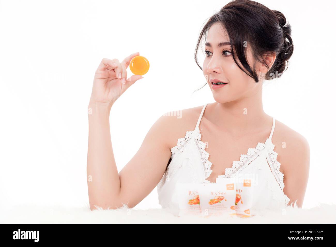 Asian young beautiful woman smiling she's holding orange handcrafted ...